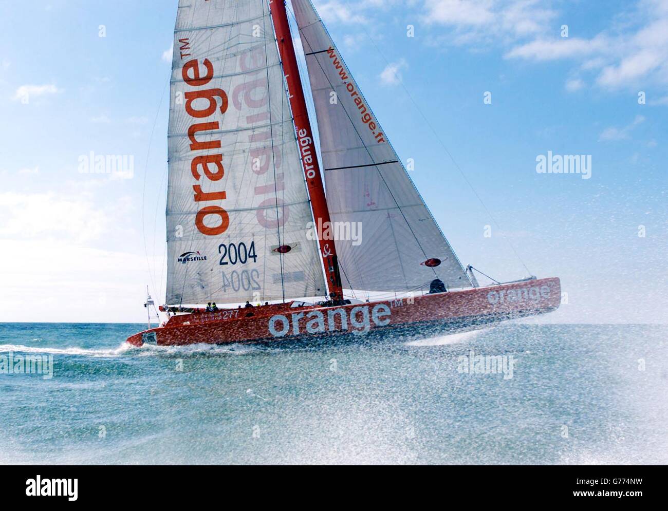 Bruno Peyron's 110ft maxi-catamaran Orange flies out of the waters of ...