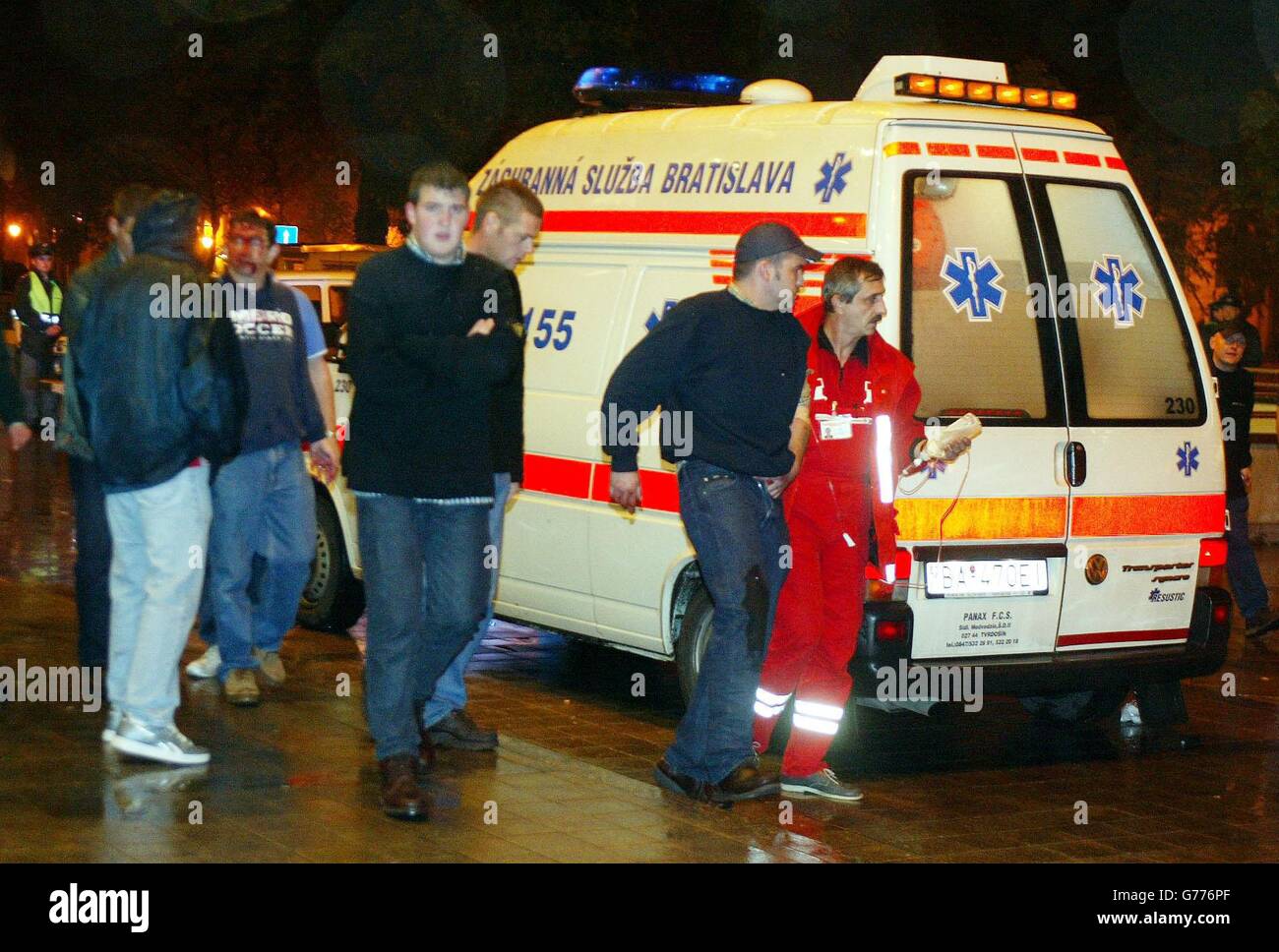 An England fan (centre right) is helped into an ambulance after being ...