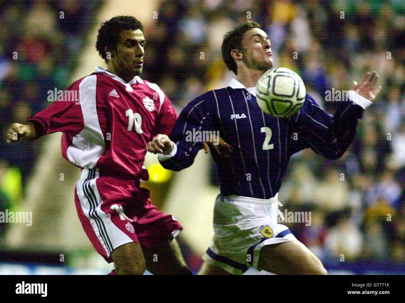 Scotland`s Maurice Ross (right) holds off Canada`s Dwayne de Rosario ...