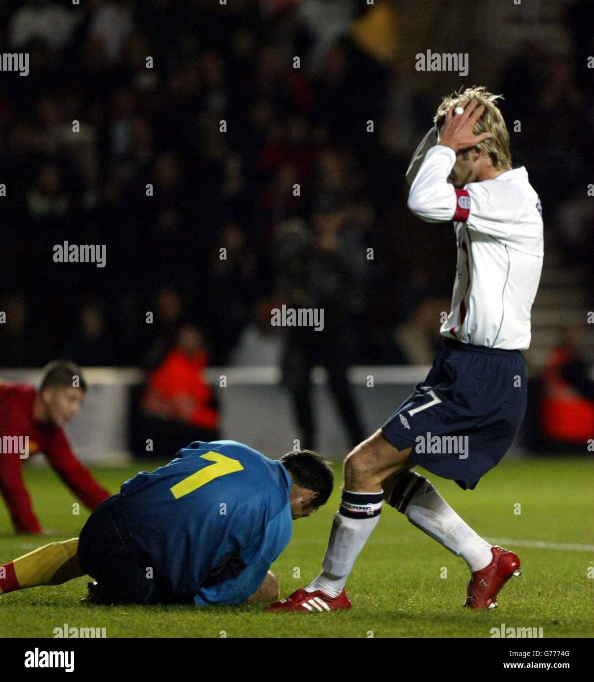 England's David Beckham (right) holds his head in dejection after ...