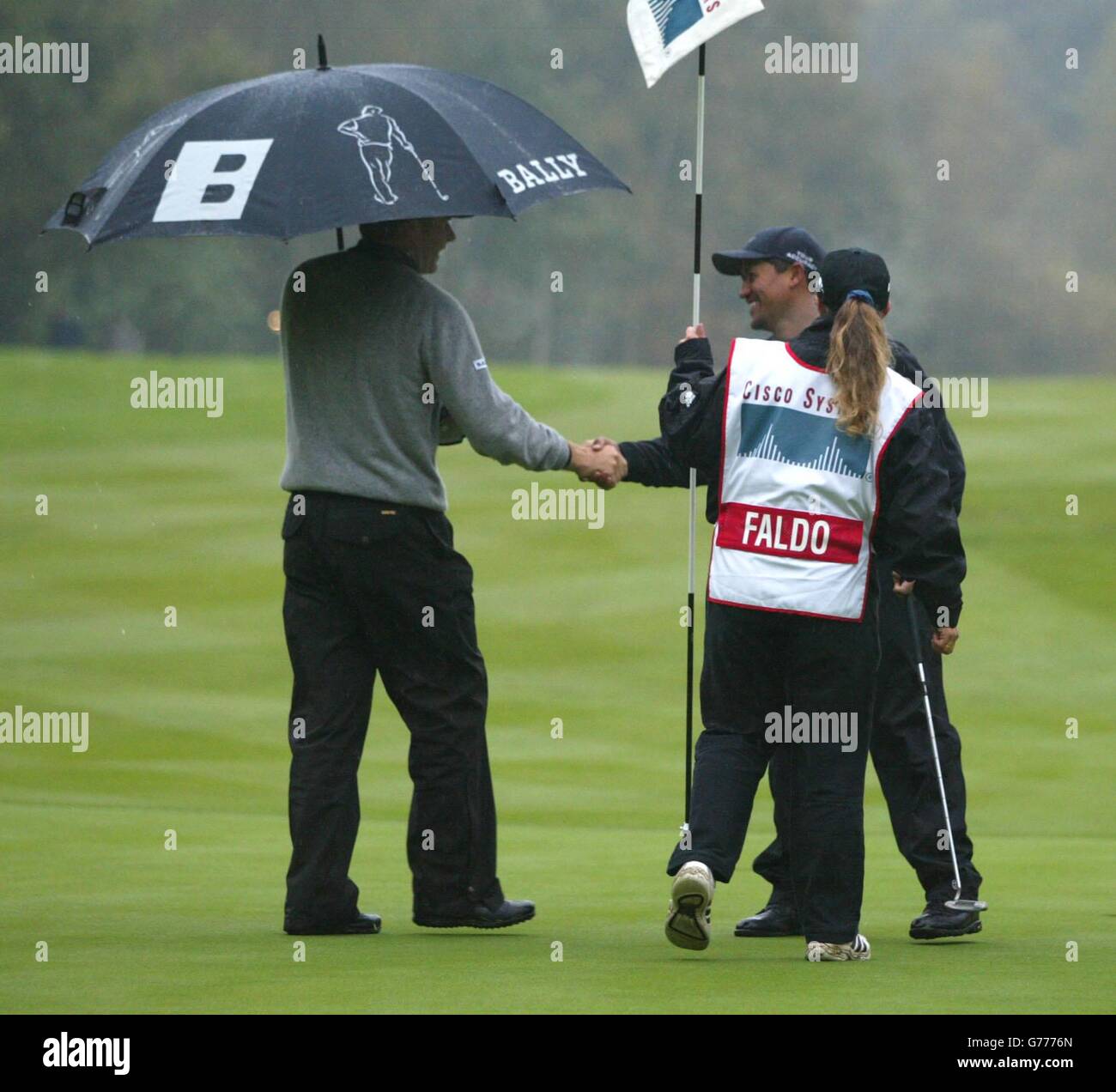It's all over on the 43rd hole (17th) as Nick Faldo (under brolly ...