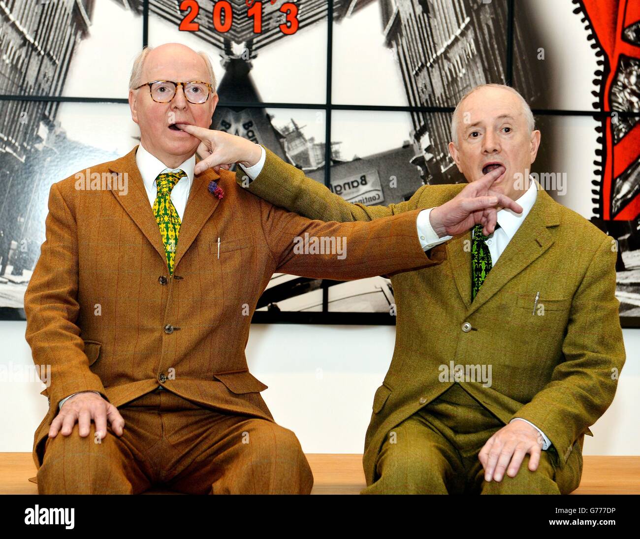 Gilbert & George (left) sit in front of their artwork City Lights ...