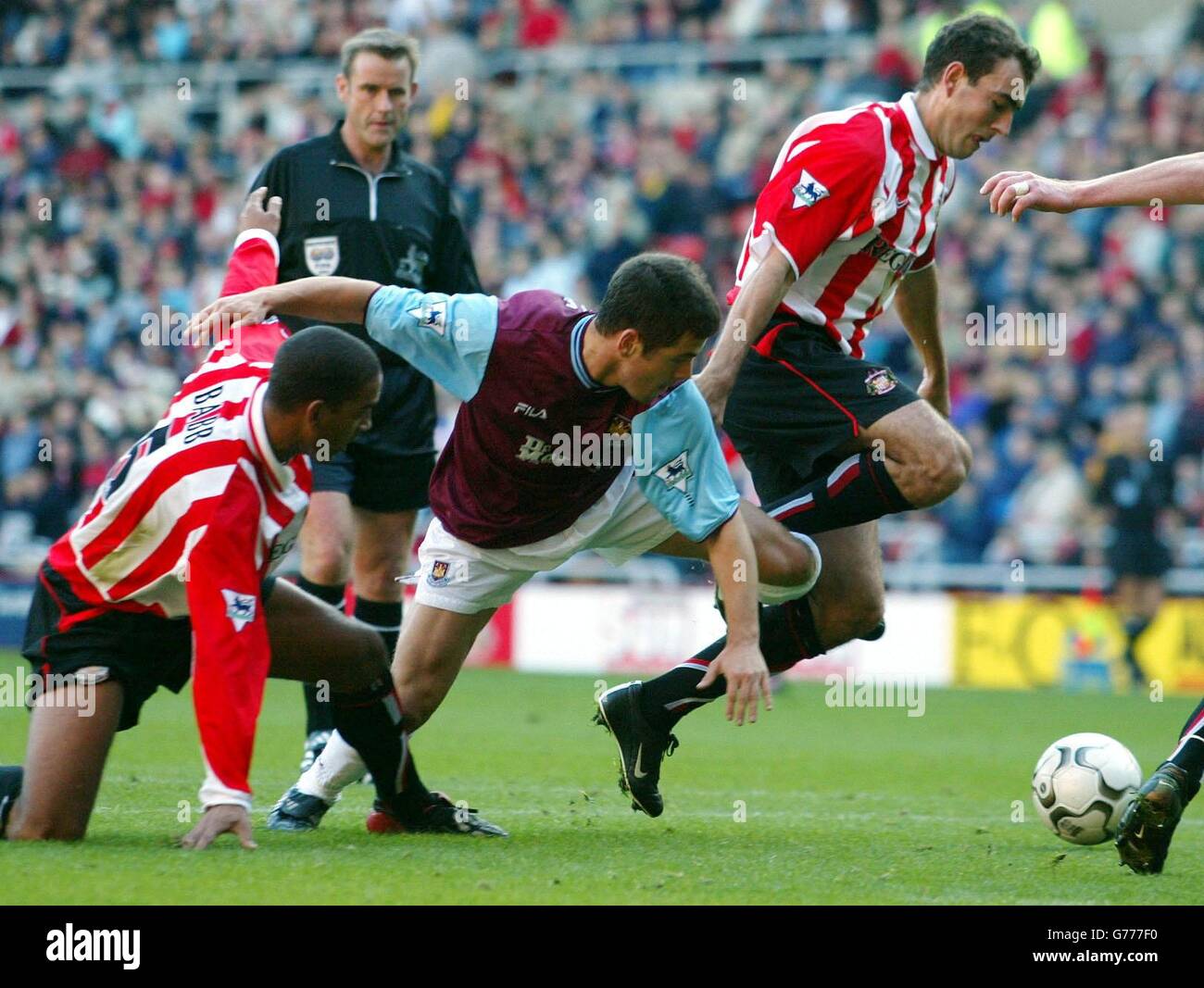 Sunderland's Gavin McCann (right) and Phil Babb (left) take the ball ...