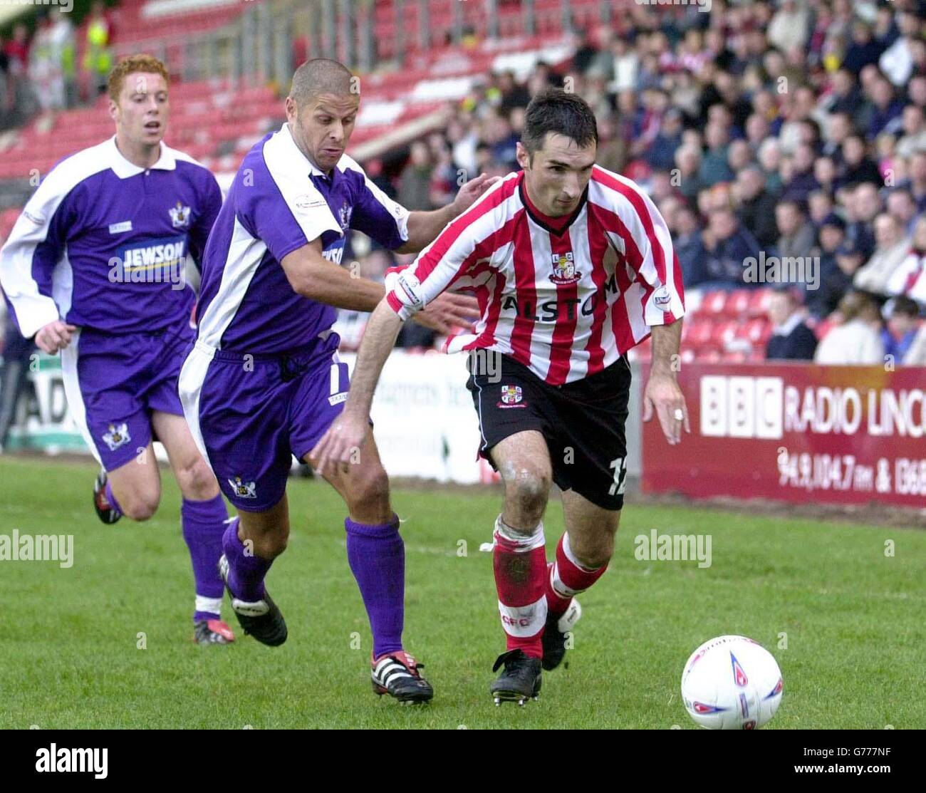 Lincoln's Simon Yeo (right) goes past Exeter's Scott Hiley during their ...