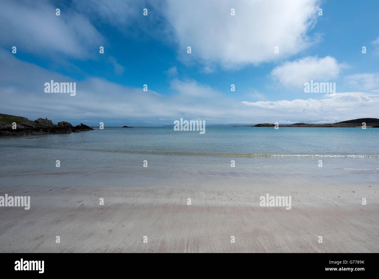 Crystal clear Atlantic sea water washing white shell sand at Mellon ...