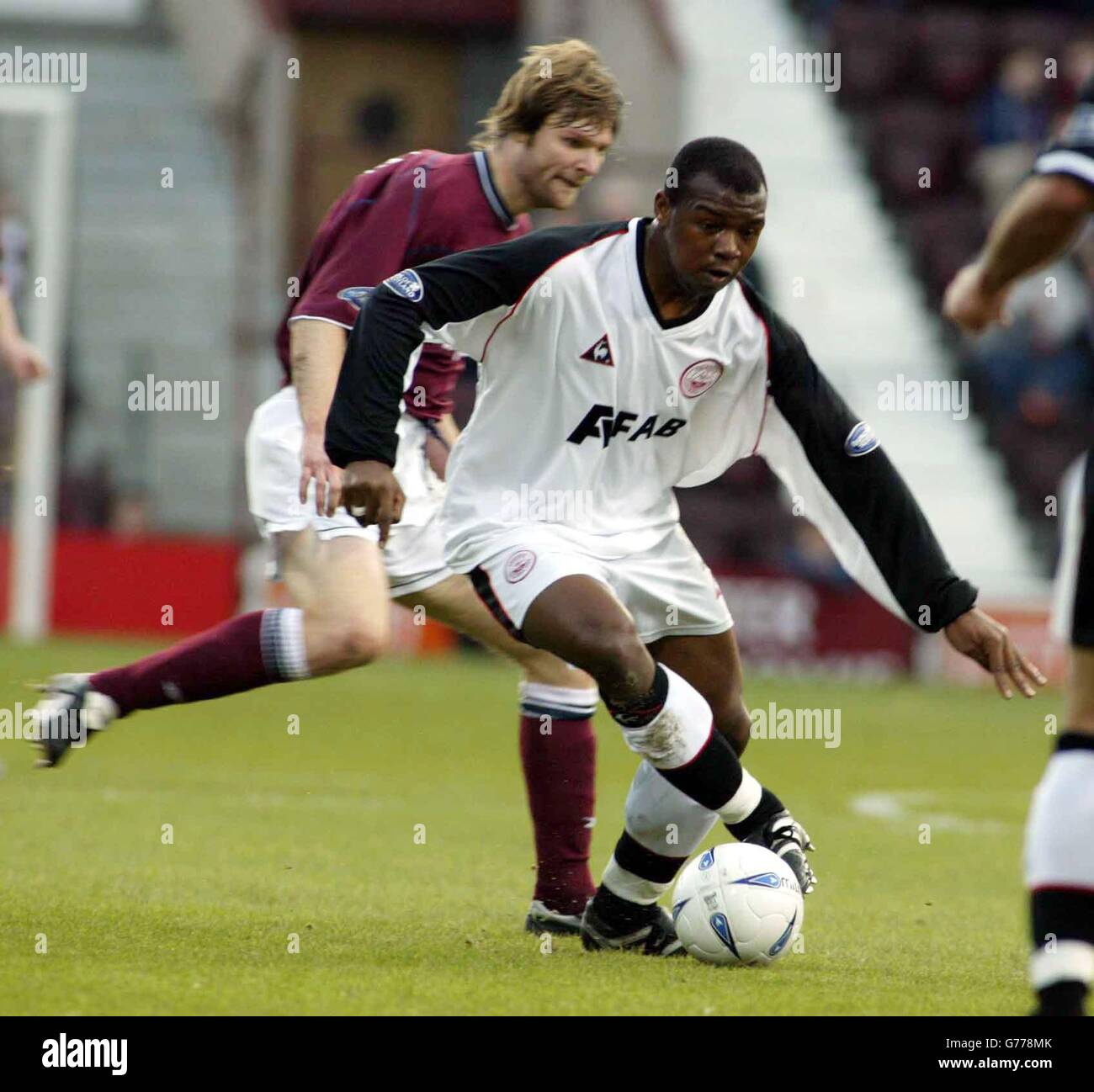 Hearts' Steven Pressley is held off by Aberdeen's Leon Mike, during ...