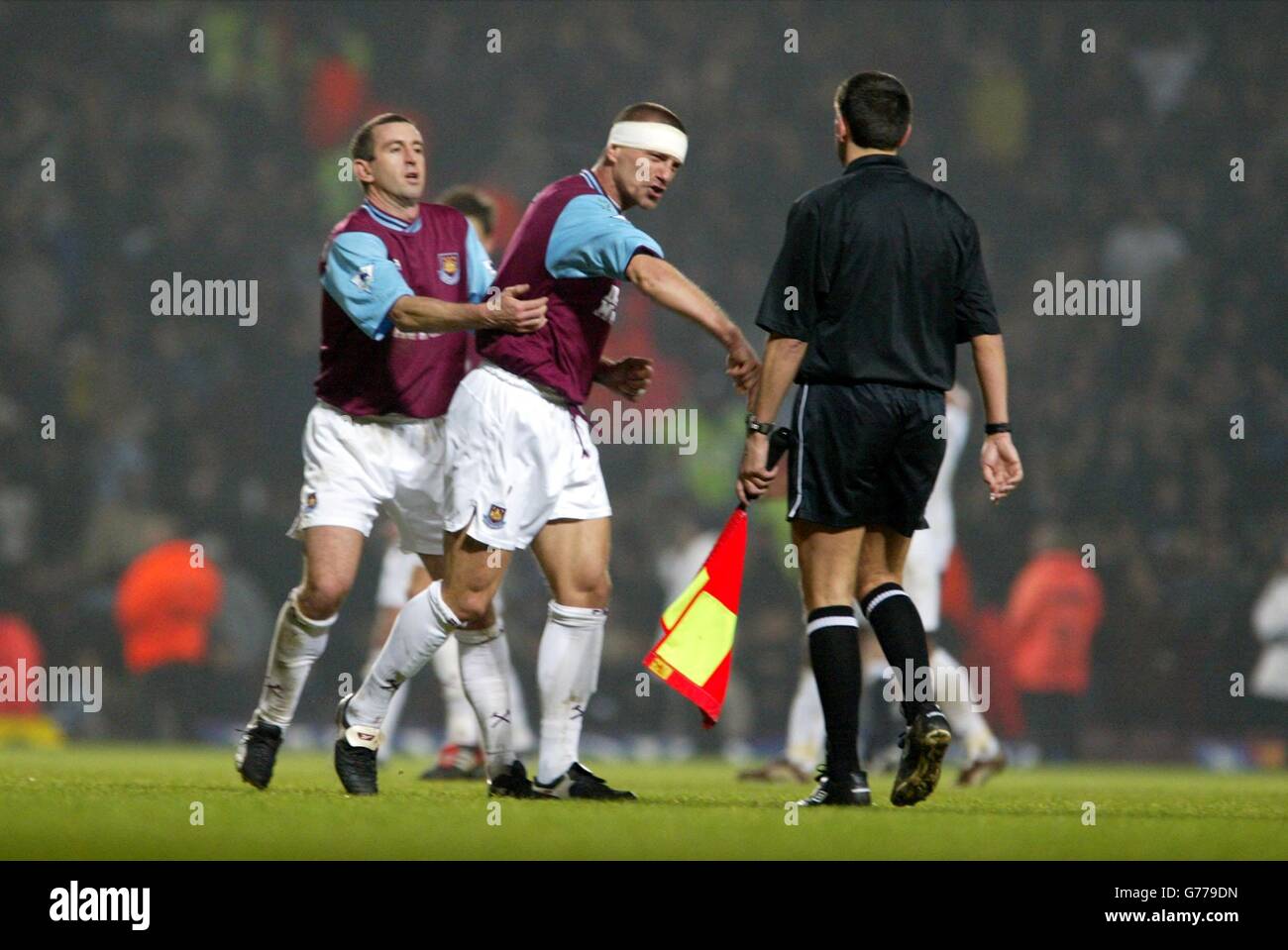 West Ham's Nigel Winterburn holds back Tomas Repka from the linesman ...