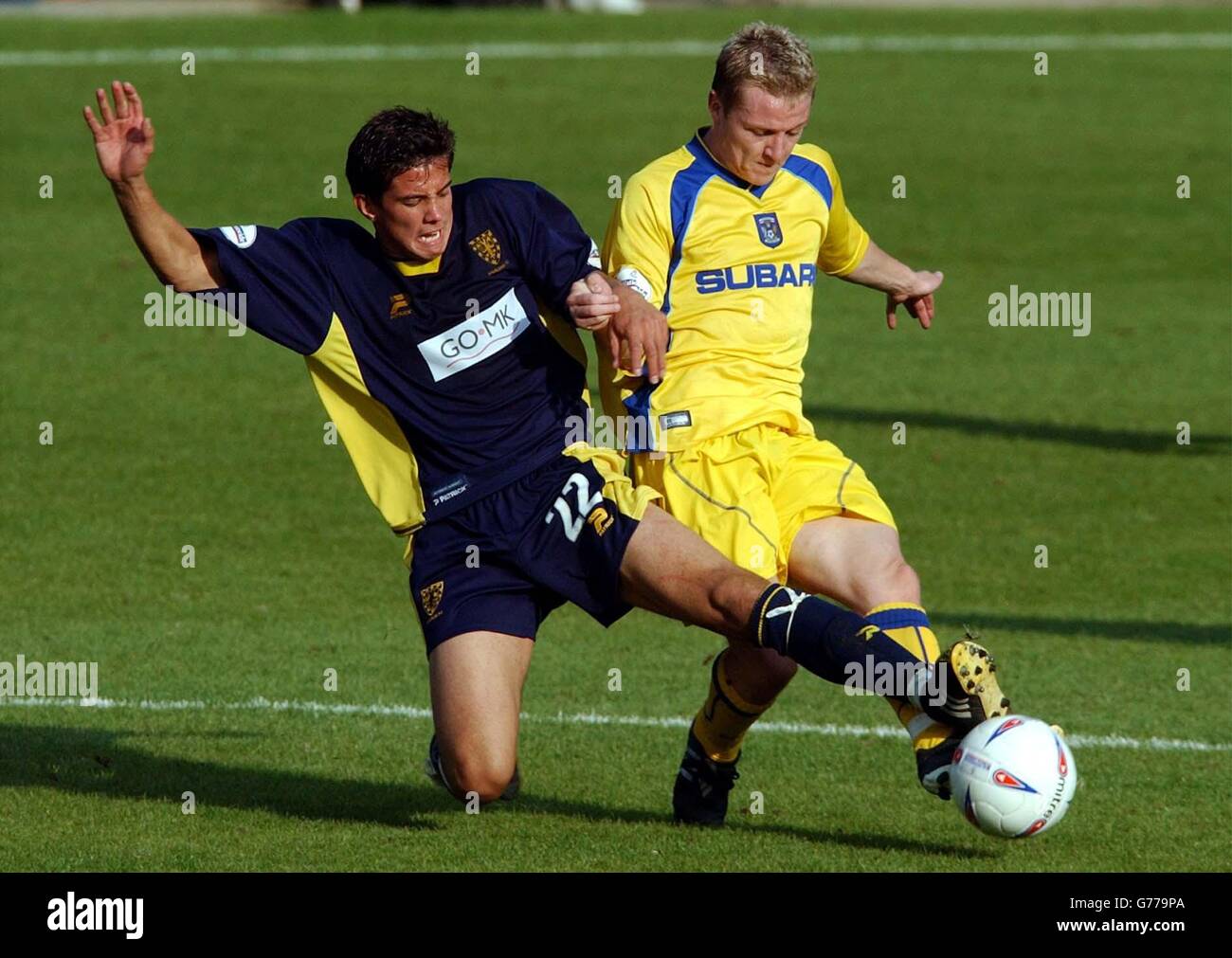 Rob Gier (left) of Wimbledon tackles Coventry's Gary McSheffrey, during ...