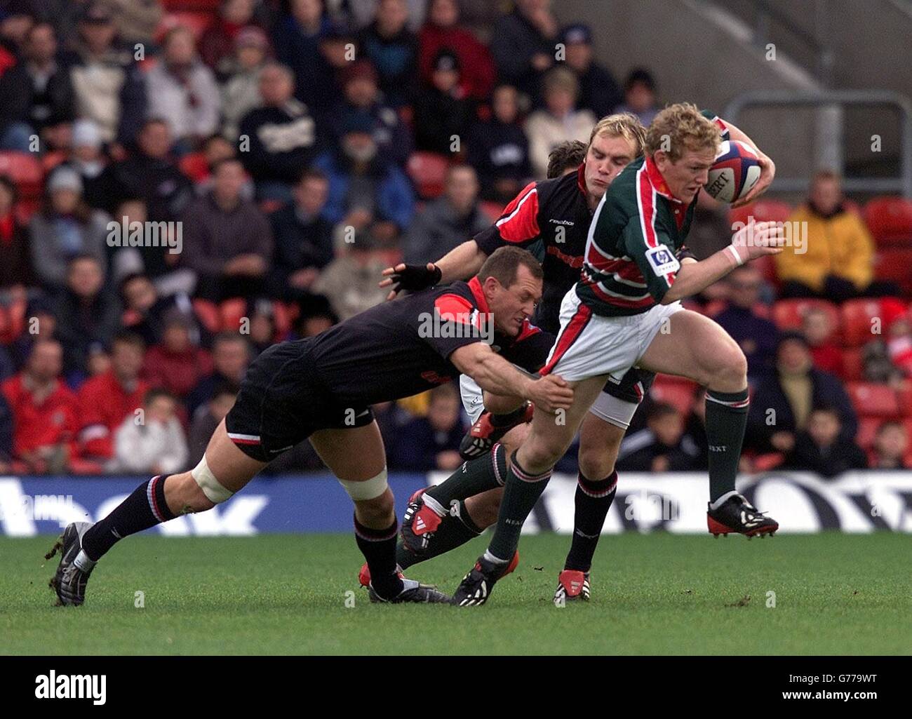 Leicester's Sam Vesty breaks through the tackle of Saracens Richard ...