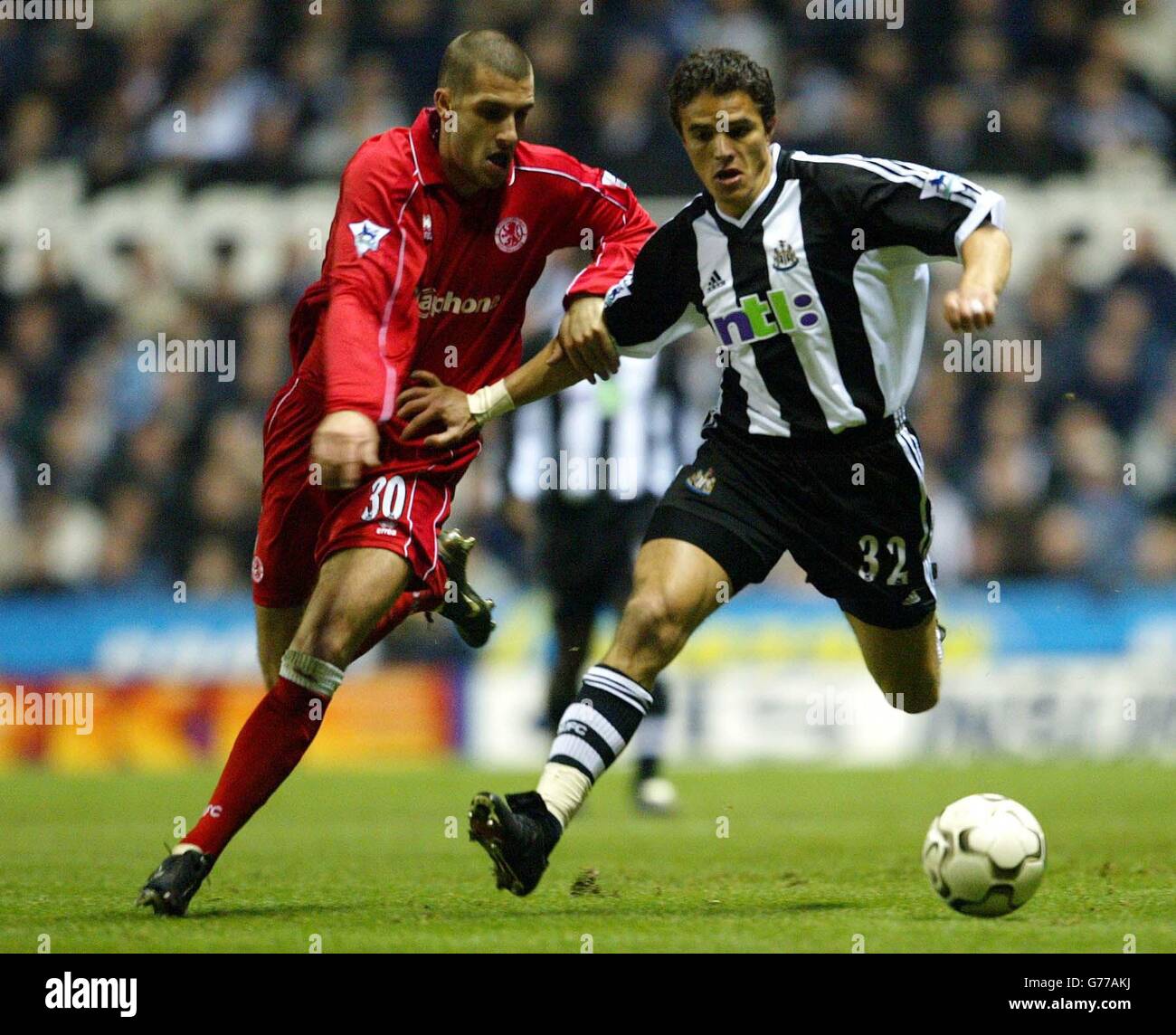 Newcastle's Laurent Robert (right) battles with Middesbrough's Steven ...