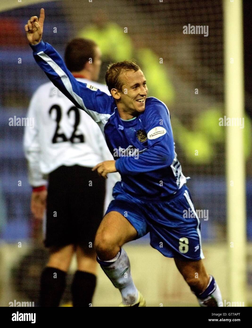 Wigan's Neil Roberts celebrates his opening goal against Manchester ...