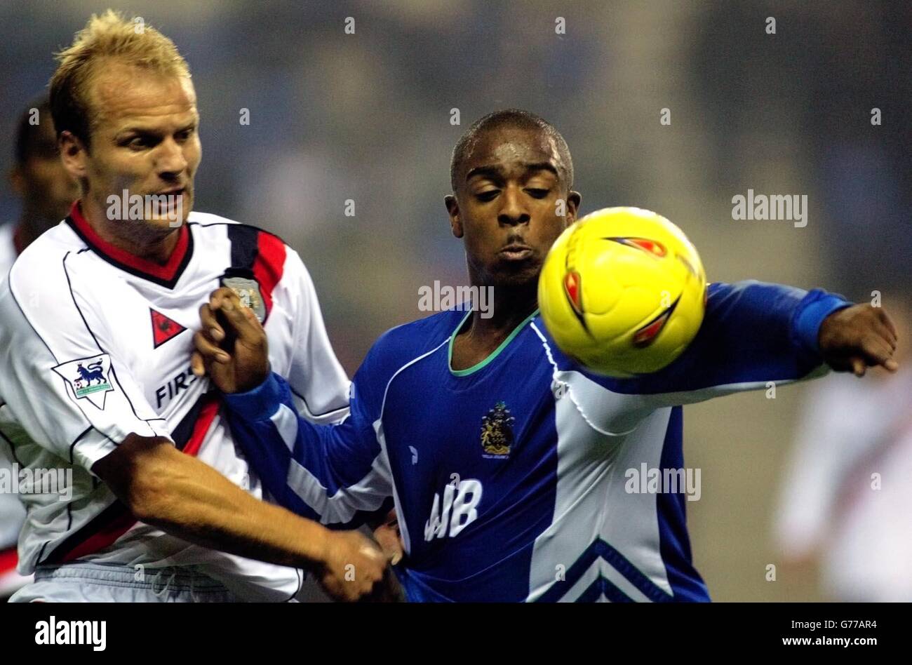 Wigan's Nathan Ellington (right) holds off Manchester City's Gerard ...