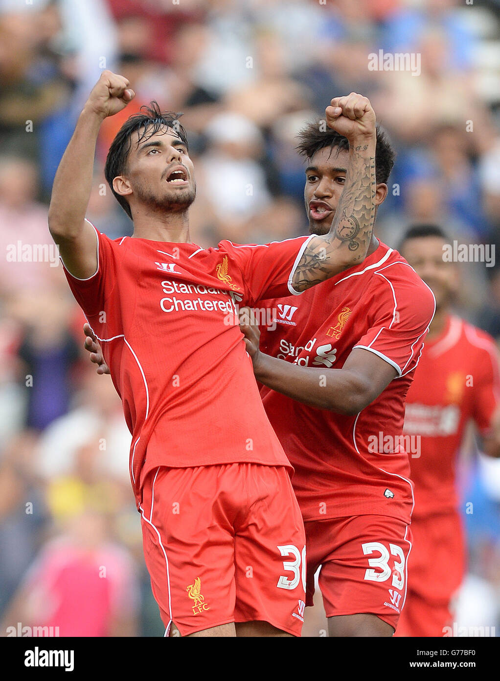 Liverpool's Suso (left) celebrates scoring his teams 1st goal against ...