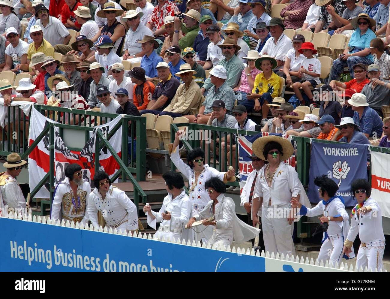 A group of fans dressed as Elvis Presley entertain the crowd during the ...