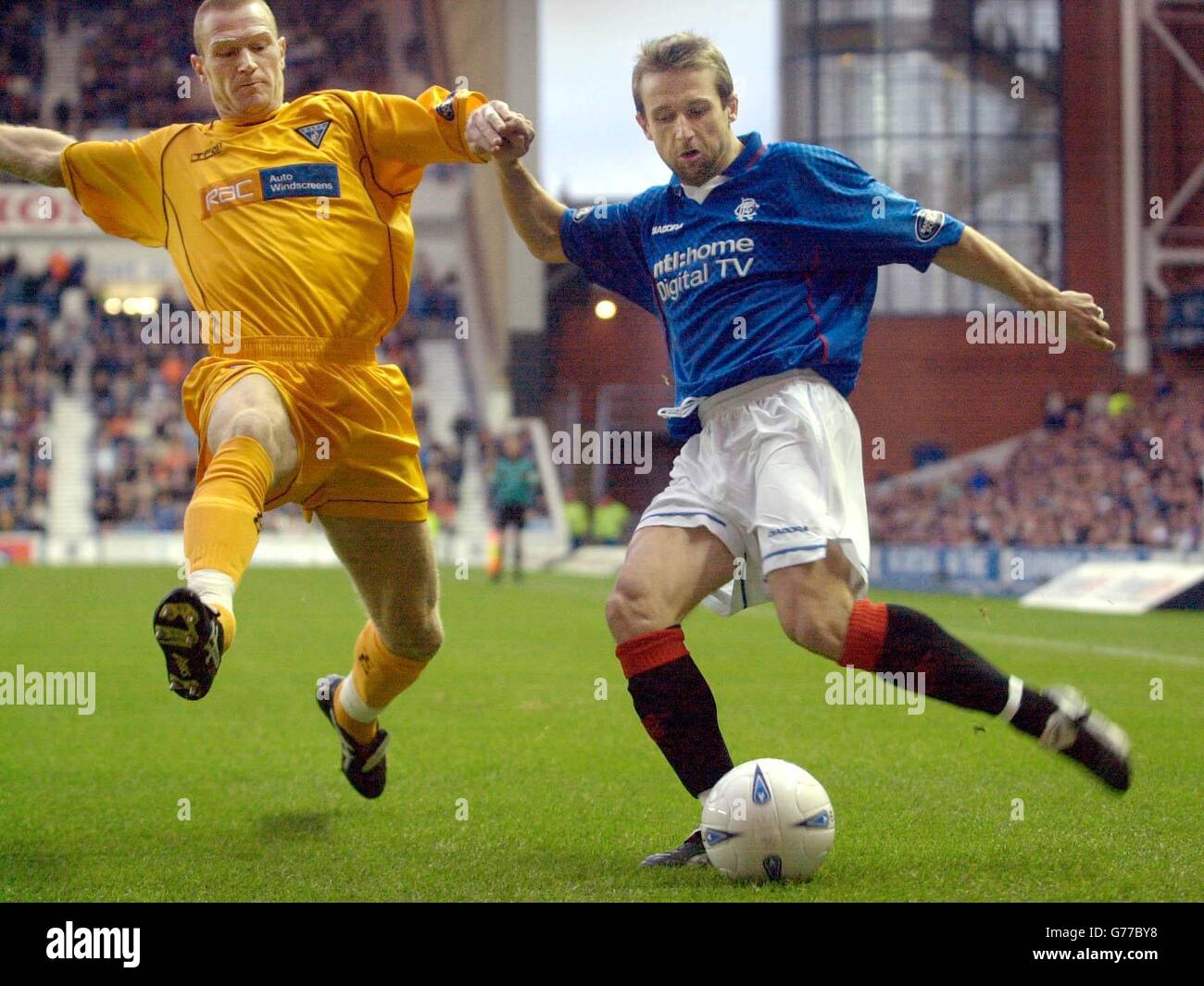 Ranger's Neil McCann (right) goes past Dunfermline's Scott Wilson ...