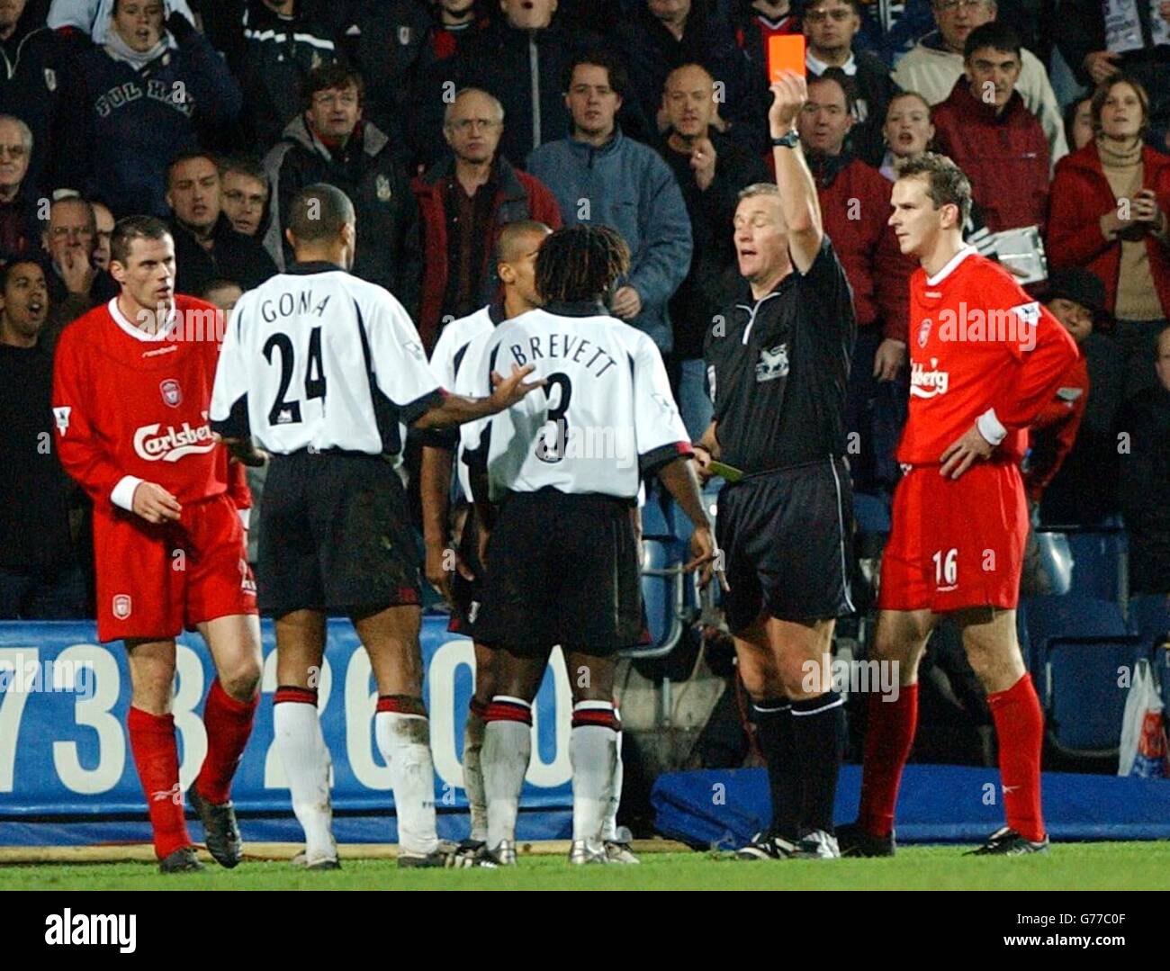 Fulham's Alain Goma (2nd left) is shown the red card by referee Graham ...