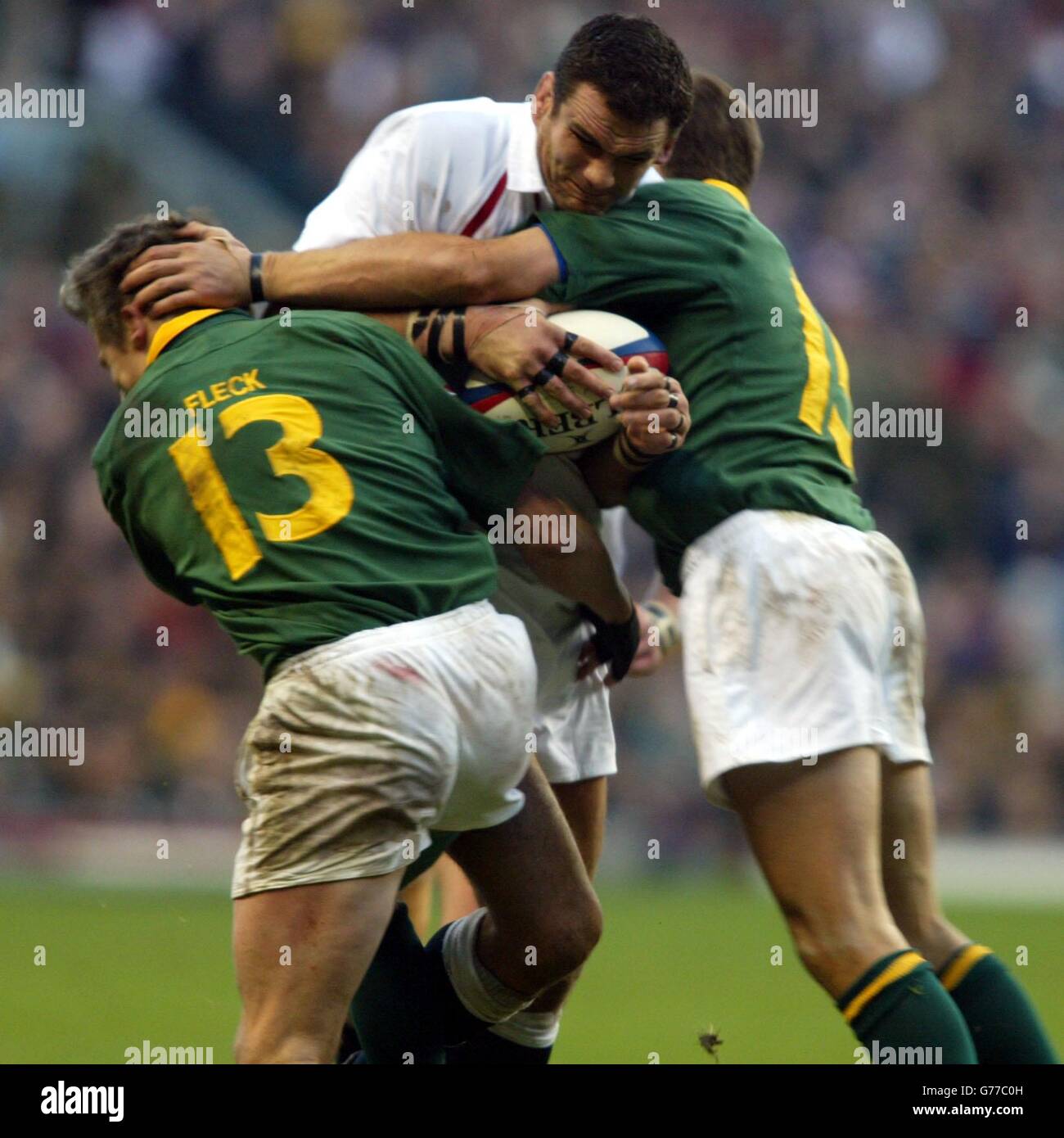 England's Martin Johnson (centre) is held up by Robbie Fleck (left) and ...