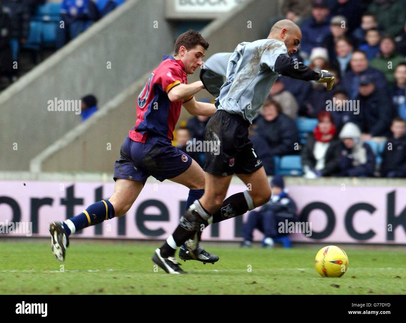 Millwall goalkeeper, Tony Warner (right) comes under pressure from ...