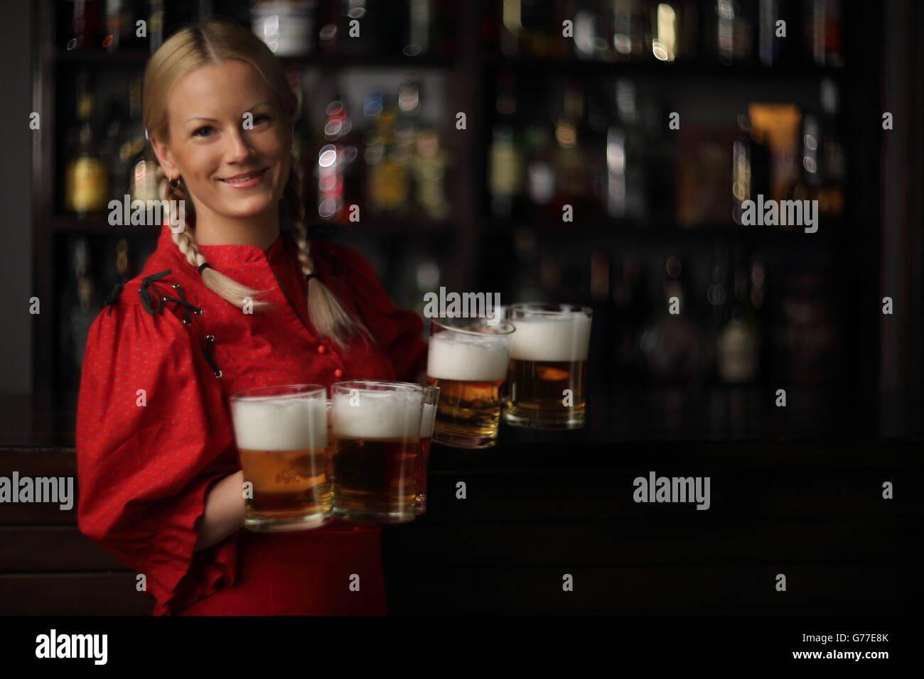 Pretty oktoberfest blonde woman holding beer bugs in bar Stock Photo ...