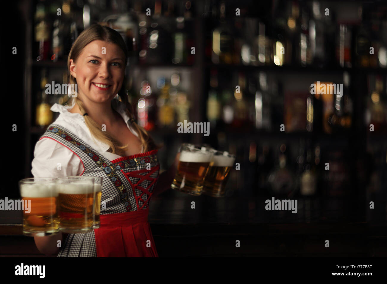 Pretty oktoberfest blonde woman holding beer bugs in bar Stock Photo ...