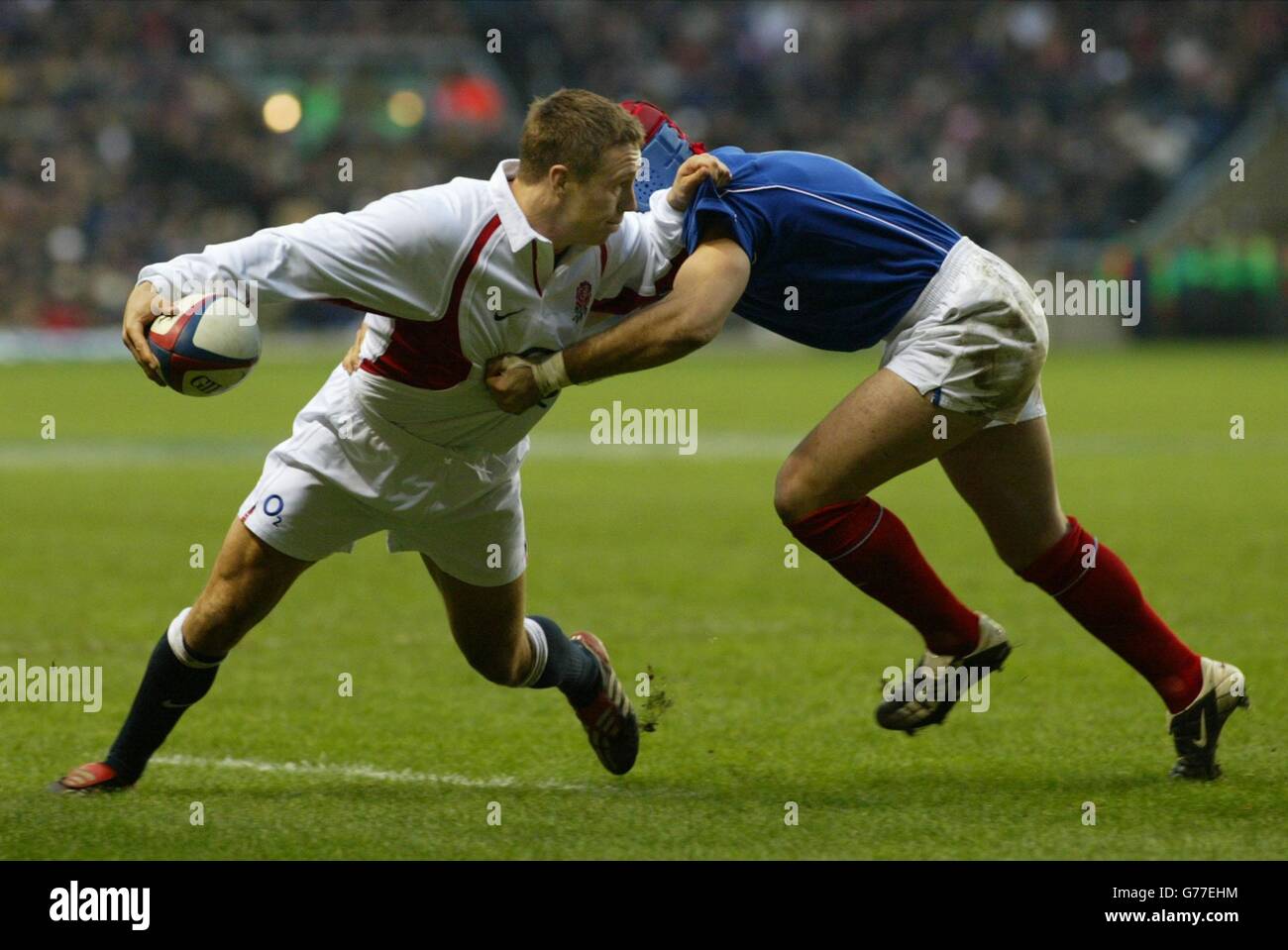 England's Jonny Wilkinson trys to slip past France's Vincent Clerc ...