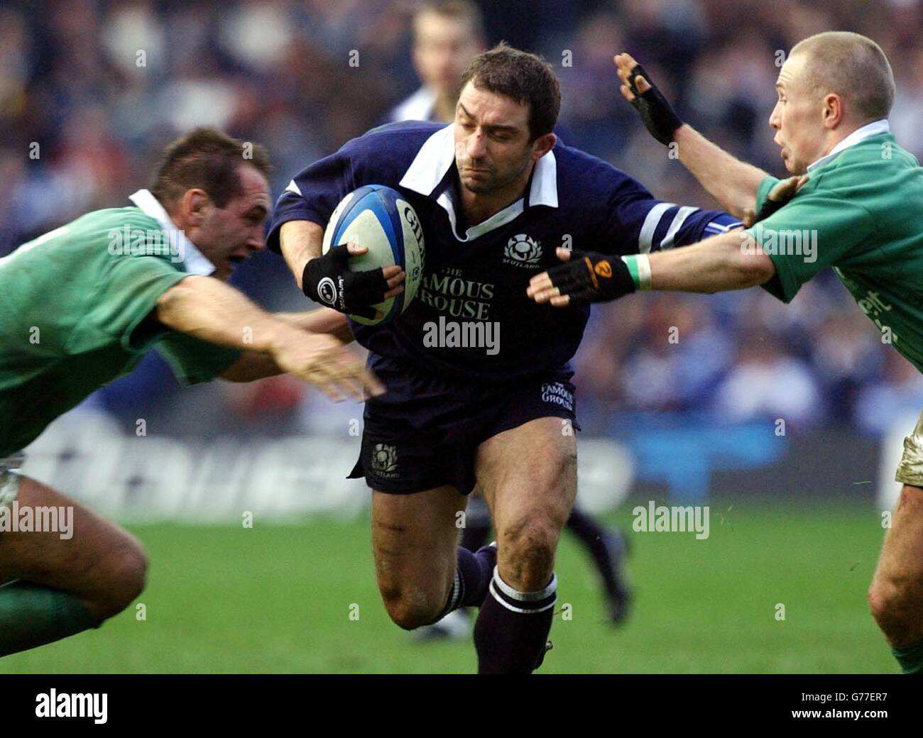 Scotland`s Bryan Redpath (centre) holds off Ireland's Peter Stringer ...