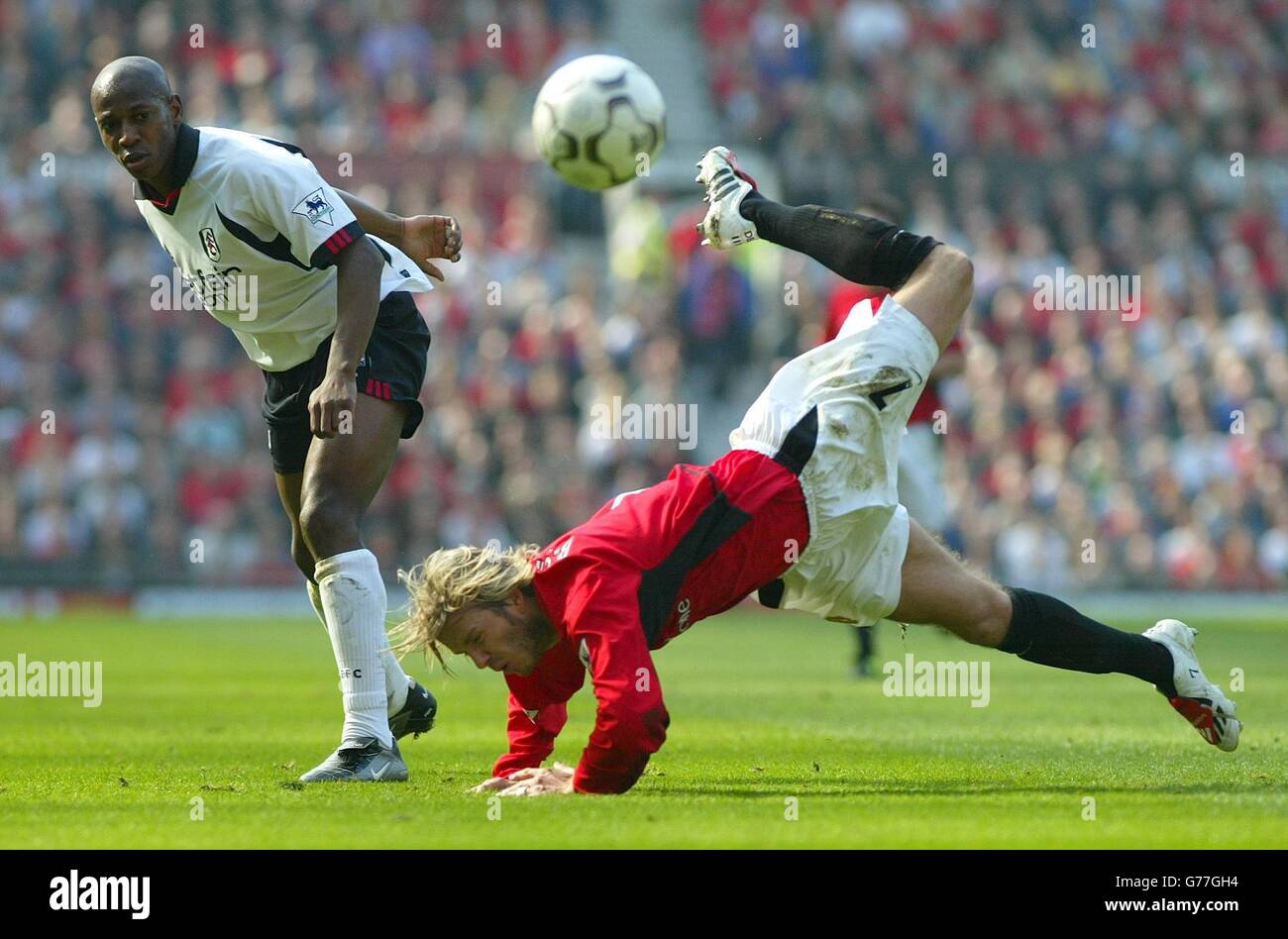 Manchester United's David Beckham falls over from a challenge from ...