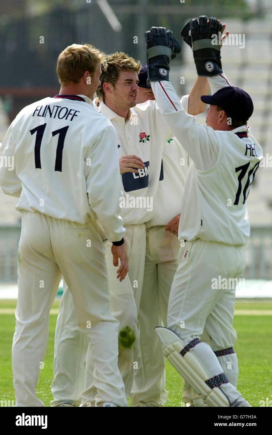 Lancashire's James Anderson (centre) celebrates the wicket of Surrey's ...