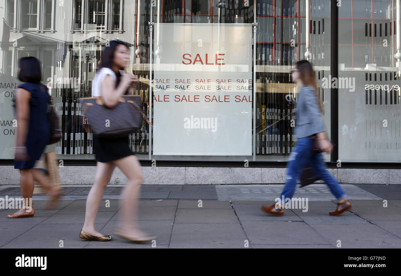 Shoppers walk past sale signs on oxford street hi-res stock photography ...