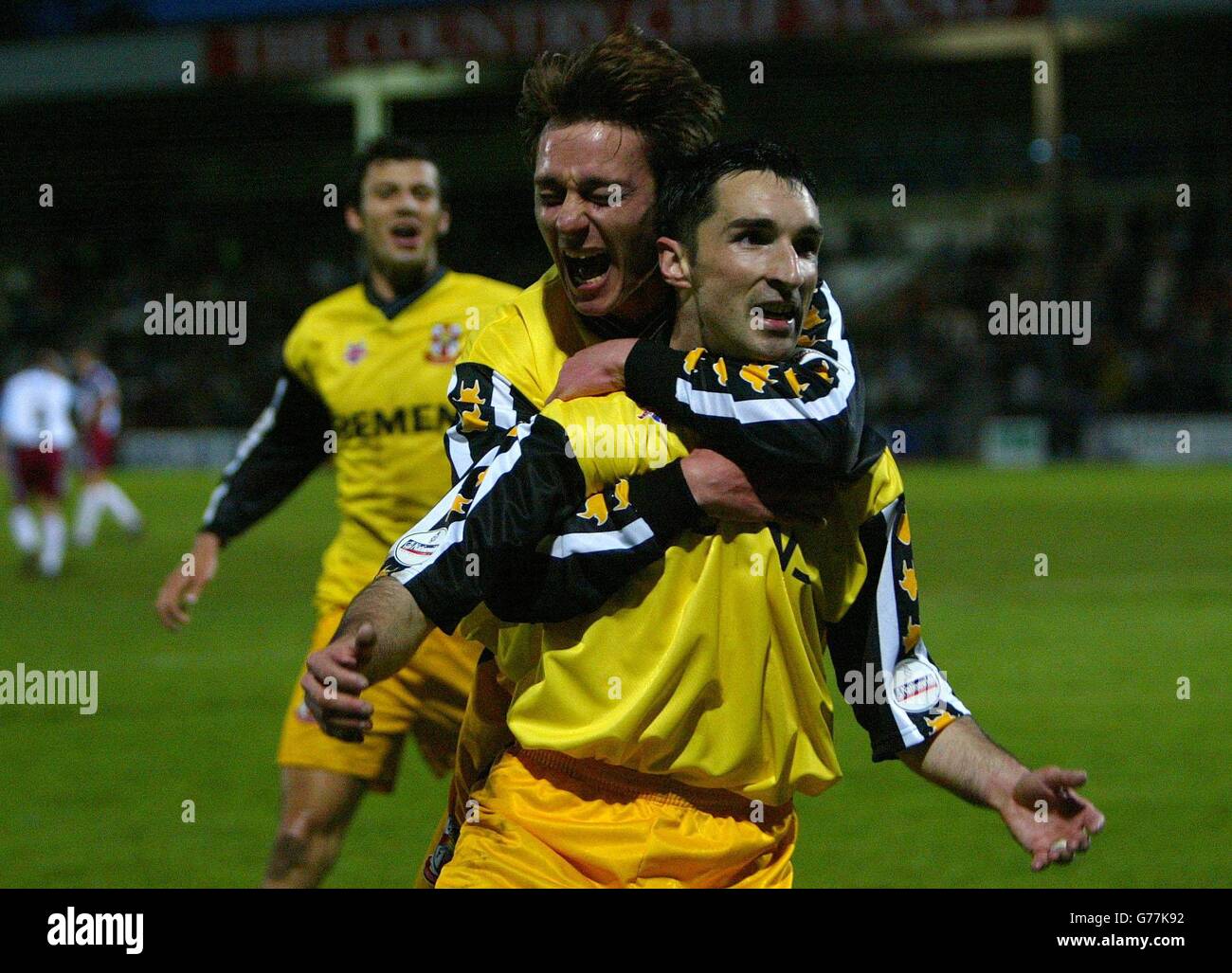 Lincoln City's Simon Yeo (right) celebrates scoring against Scunthorpe ...