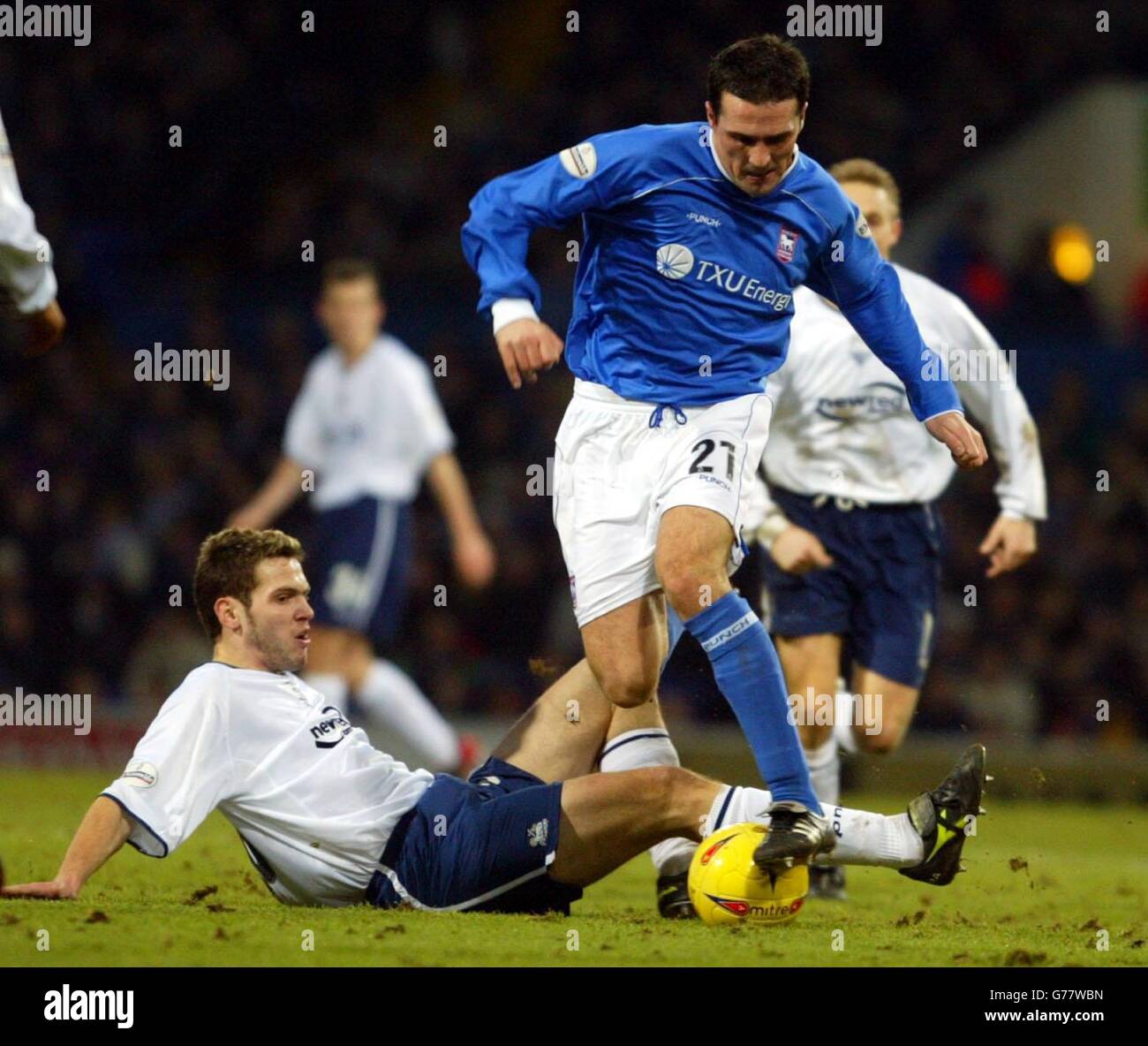 Tommy Miller of Ipswich is tackled by Preston's Lee Cartwright, during ...