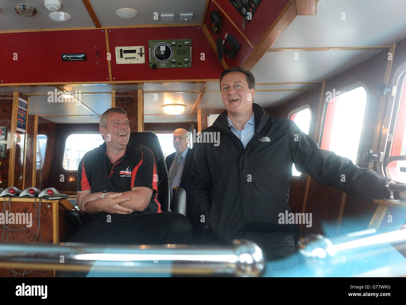 Prime Minister David Cameron as he taken out to sea on the fishing boat ...