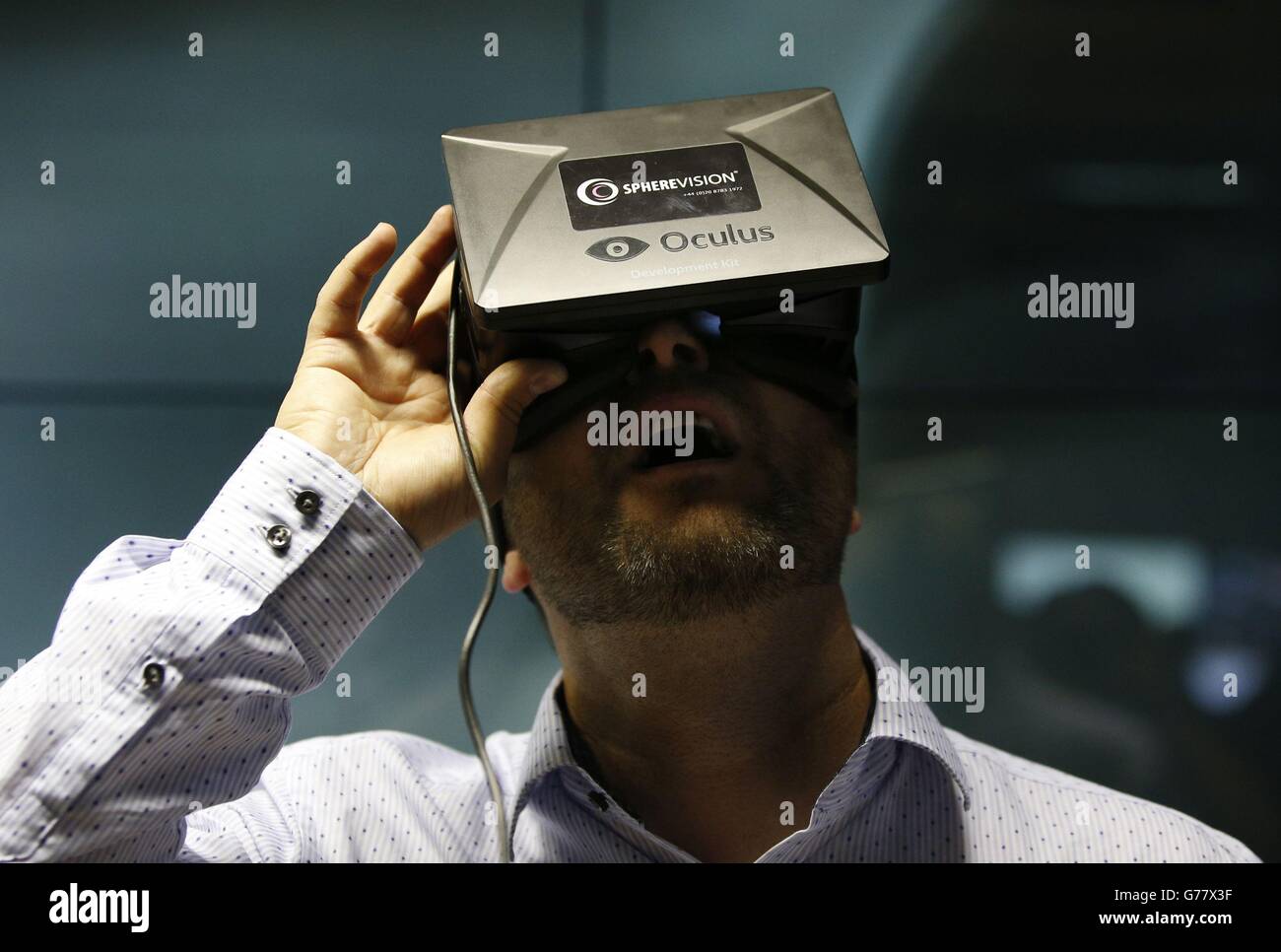 A visitor to a showcase of 3D technology interacts with an oculus ...