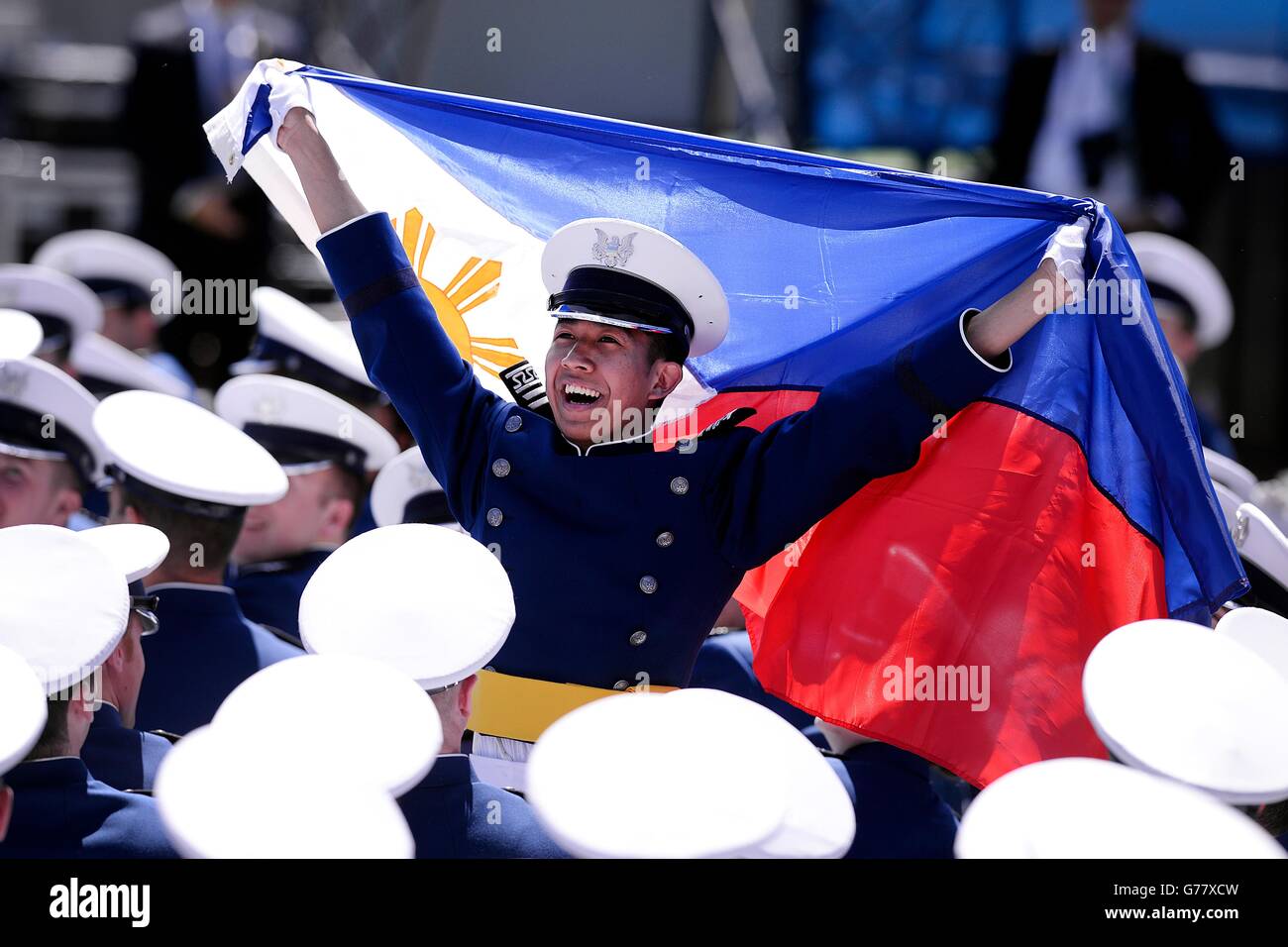 A U.S Air Force Academy cadet holds up a Philippine flag during the ...