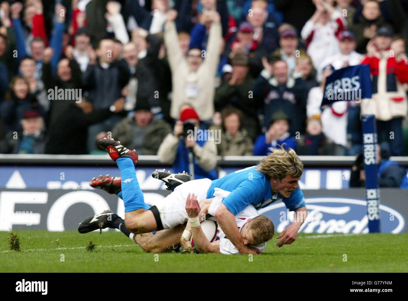 England's Josh Lewsey beats the tackle of Italy's Mirco Bergamasco (top ...