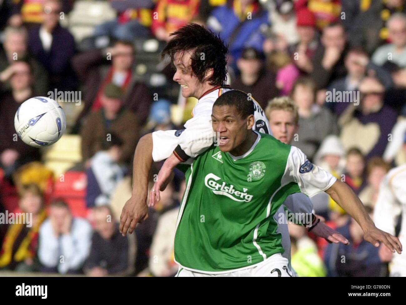 Partick Thistle's Gerry Britton beats Hibernian's Mathias Doumbe ...