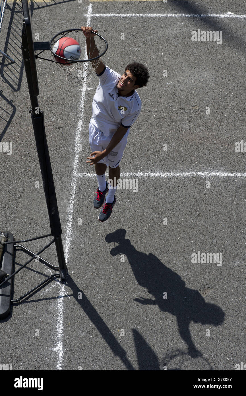A man uses the pop up basketball court during the Urban Arts Weekend at ...