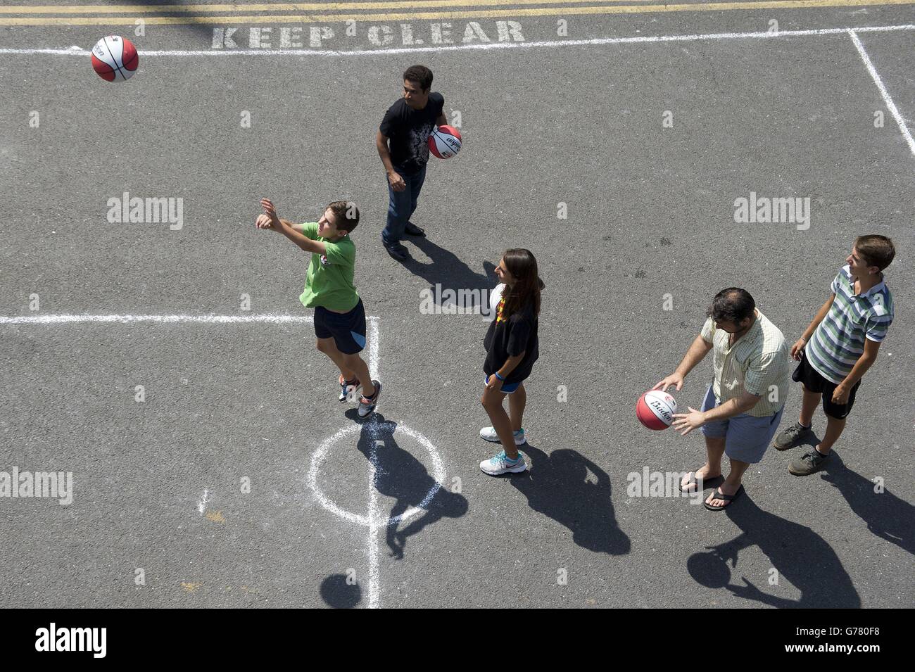 Members of the public use the pop up basketball court at the Urban Arts ...
