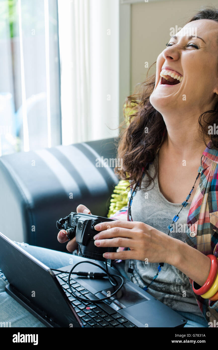 young woman laugh while browsing photos on camera Stock Photo - Alamy