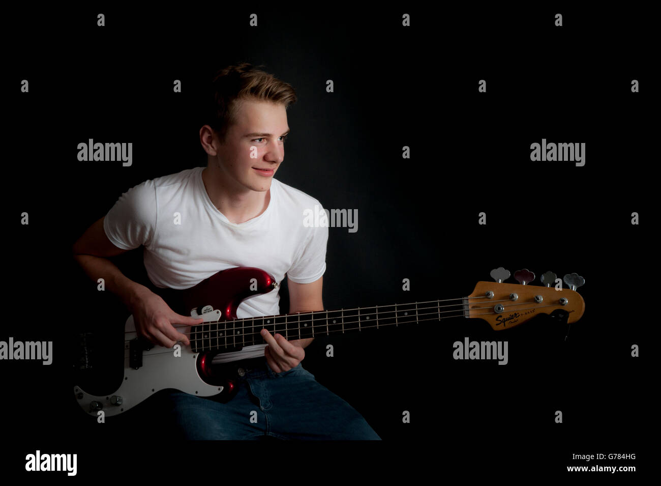 A teenage boy practices his bass guitar Stock Photo - Alamy