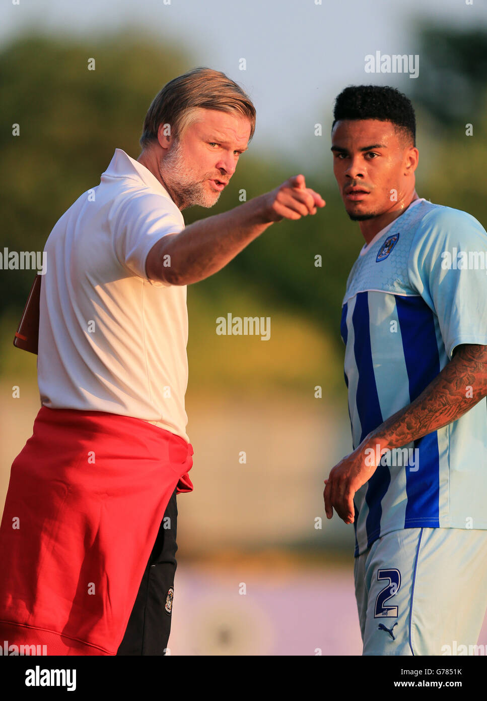 Coventry City manager Steven Pressley (left) speaks with Jordan Willis ...