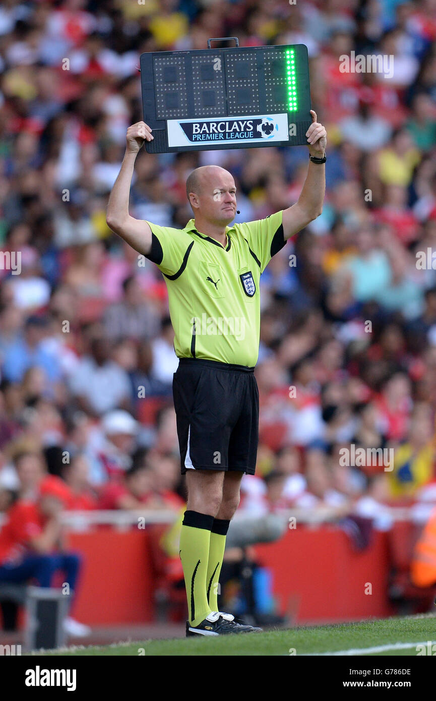 Fourth official Lee Mason holds up a Barclays Premier League LED ...