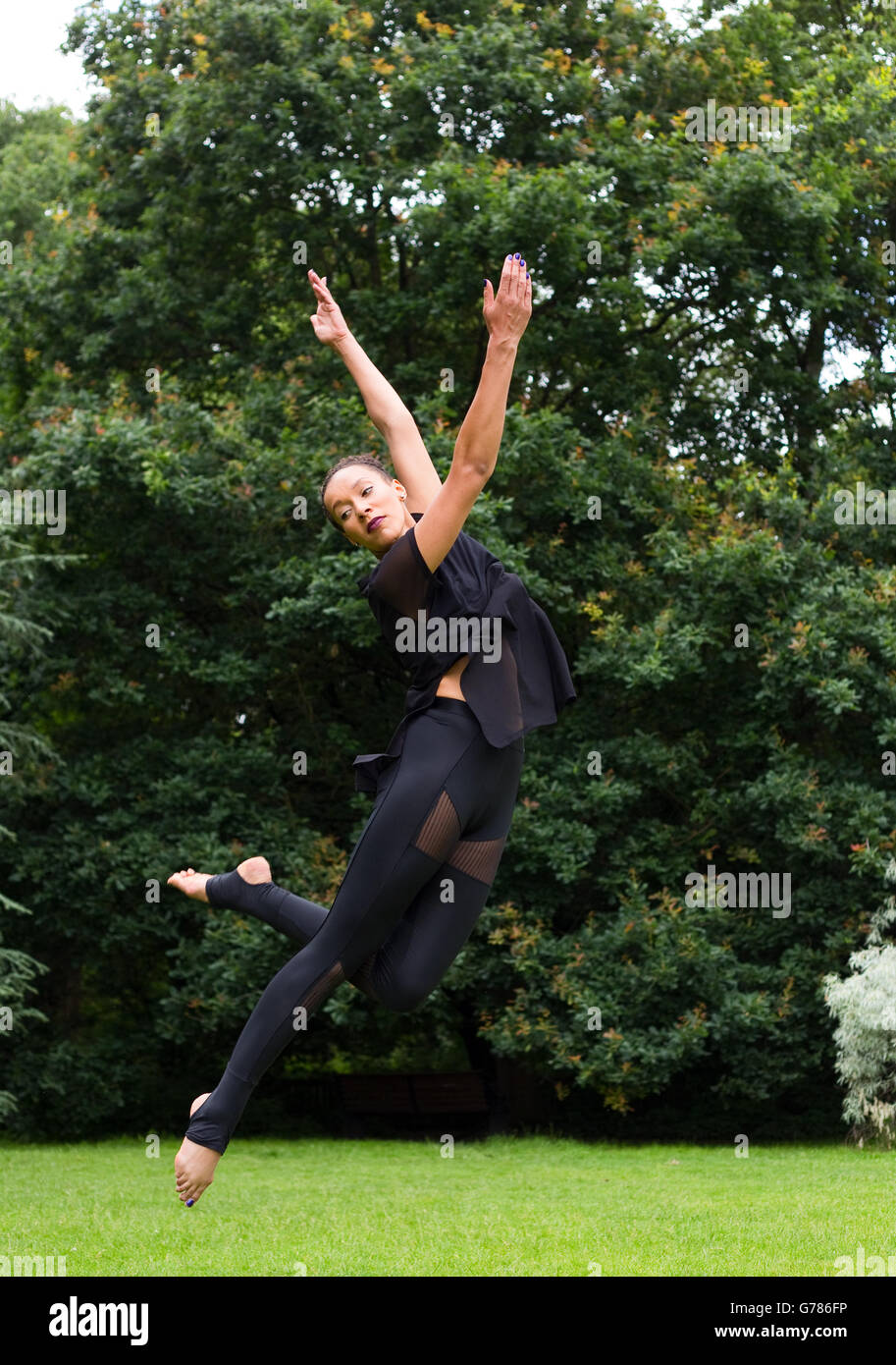 A jazz dancer performing a jump outdoors Stock Photo - Alamy