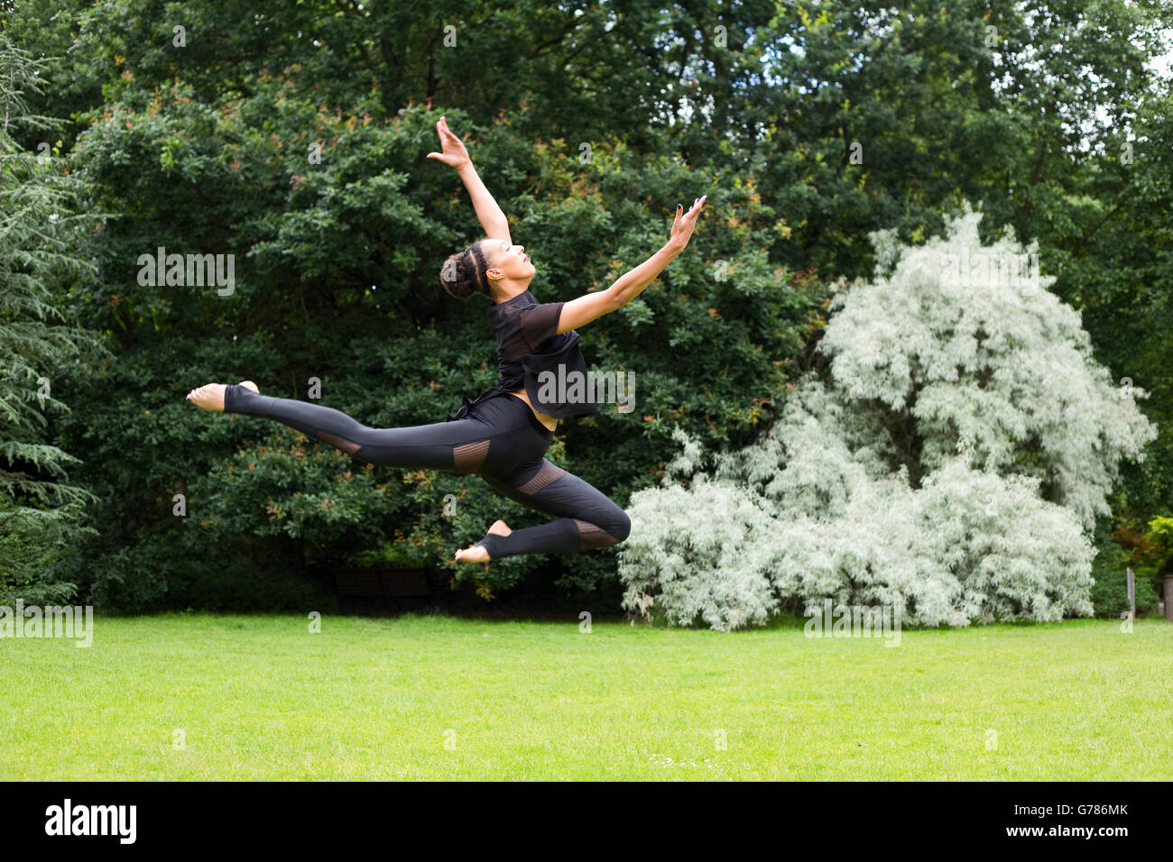 A jazz dancer performing a jump outdoors Stock Photo - Alamy
