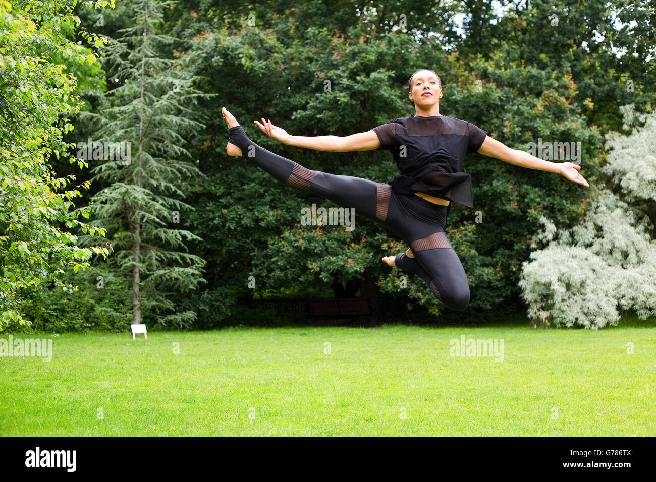 A jazz dancer performing a jump outdoors Stock Photo - Alamy