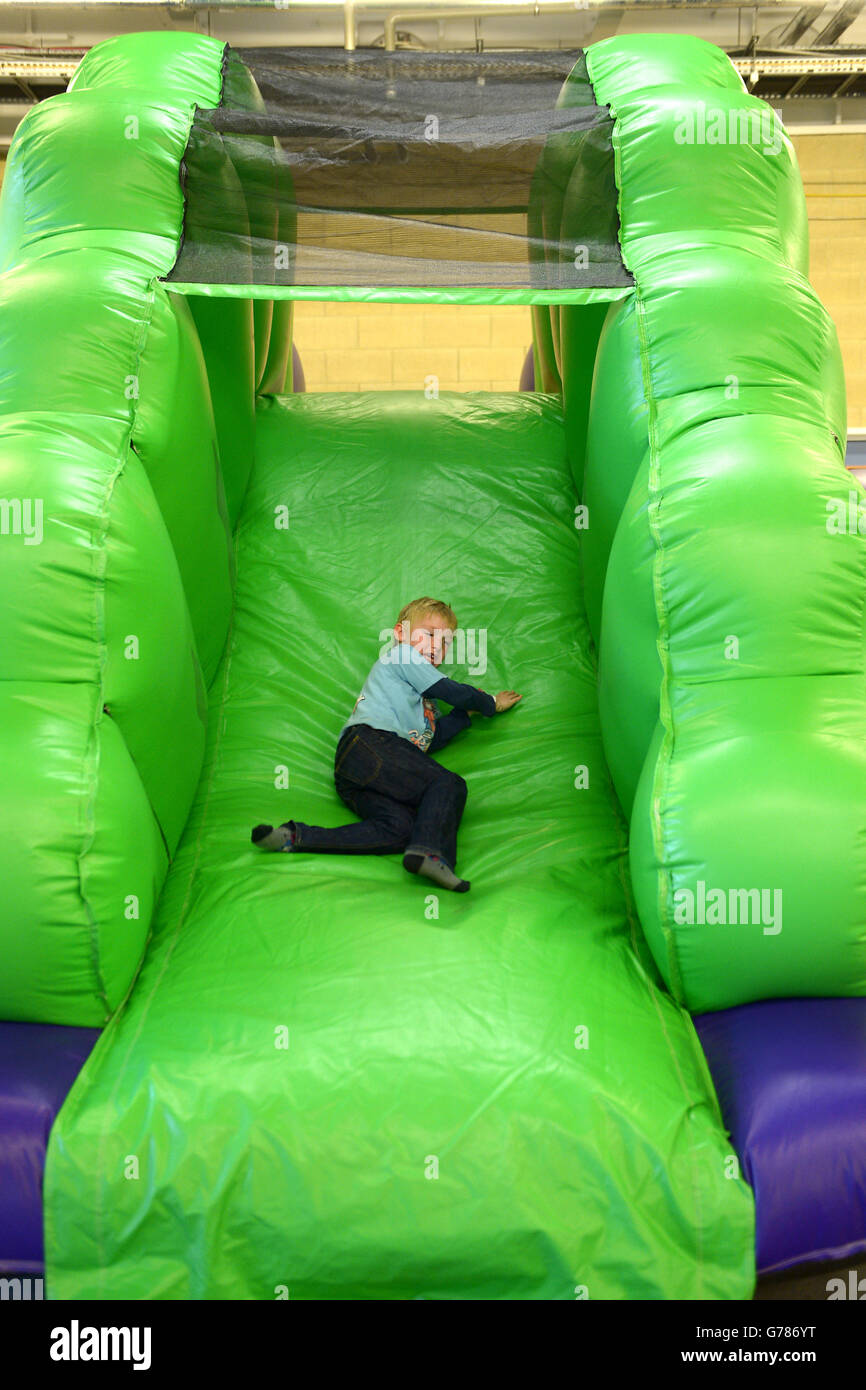 A young Surrey fan on the Dino Bouncy Slide in Lambeth Hall of the Kia ...
