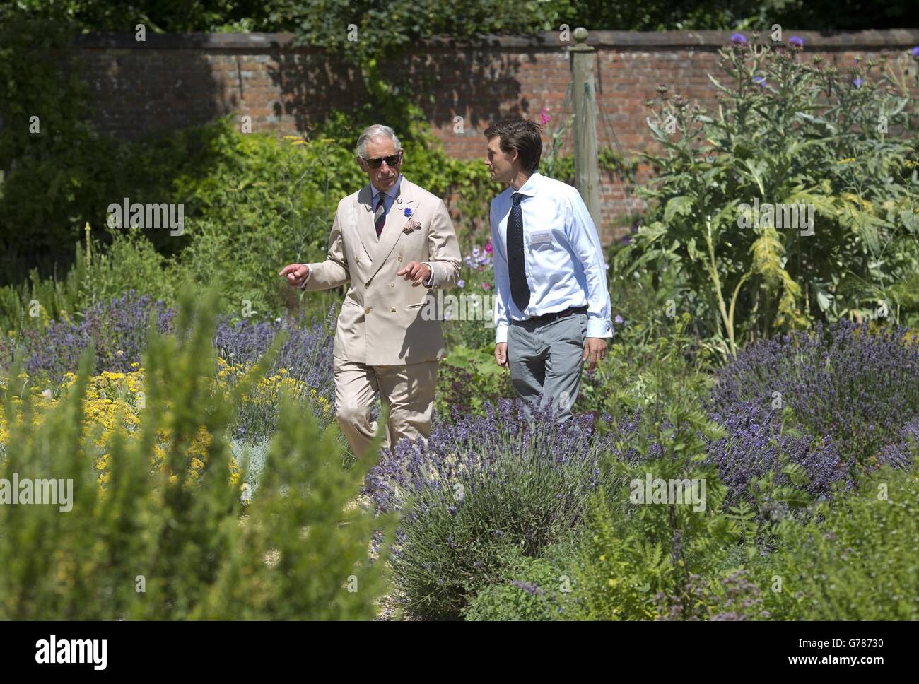 The Prince of Wales and Richard Goring walk through the gardens after ...