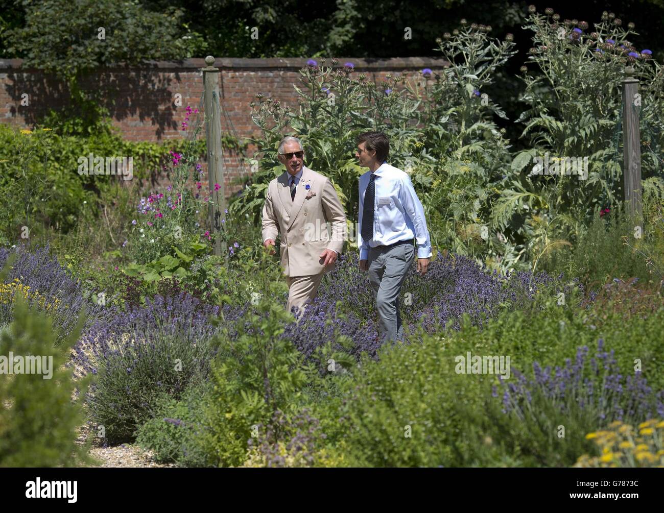 The Prince of Wales and Richard Goring walk through the gardens after ...