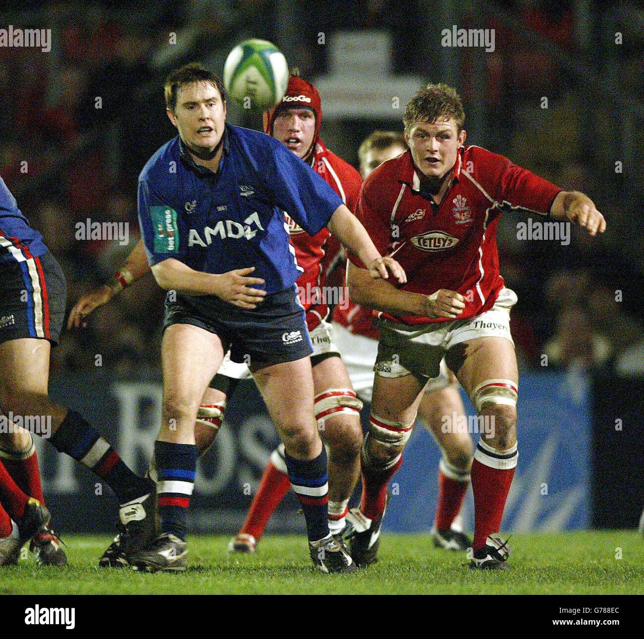 Sale Sharks scrum-half Nick Walshe (left) makes his pass as Llanelli's ...