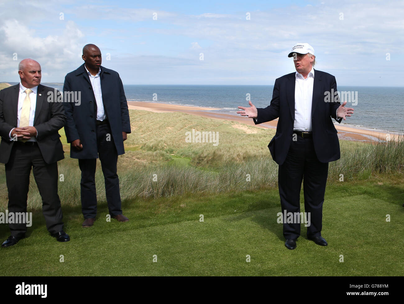 Donald Trump chats with the media on the 14th tee whilst on a tour of ...